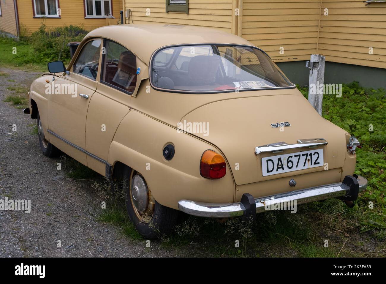 Vardo, Norway - August 3, 2022: An old yellow timer classic Saab 96 is ...