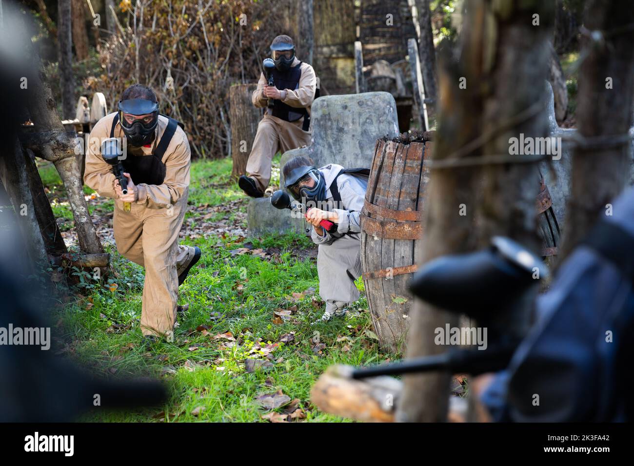 People playing paintball outdoors Stock Photo - Alamy