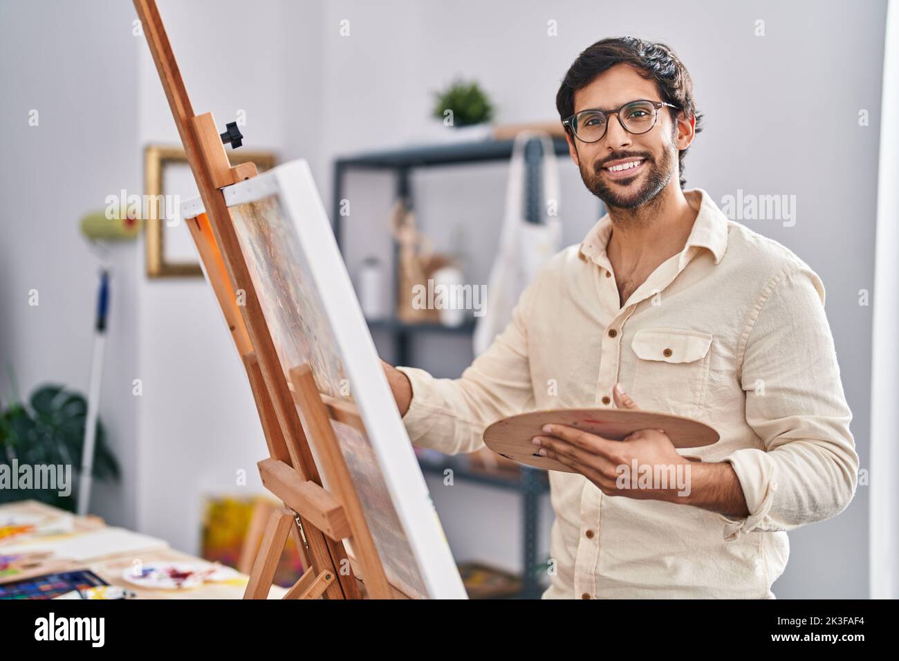 Young hispanic man artist smiling confident drawing at art studio Stock ...