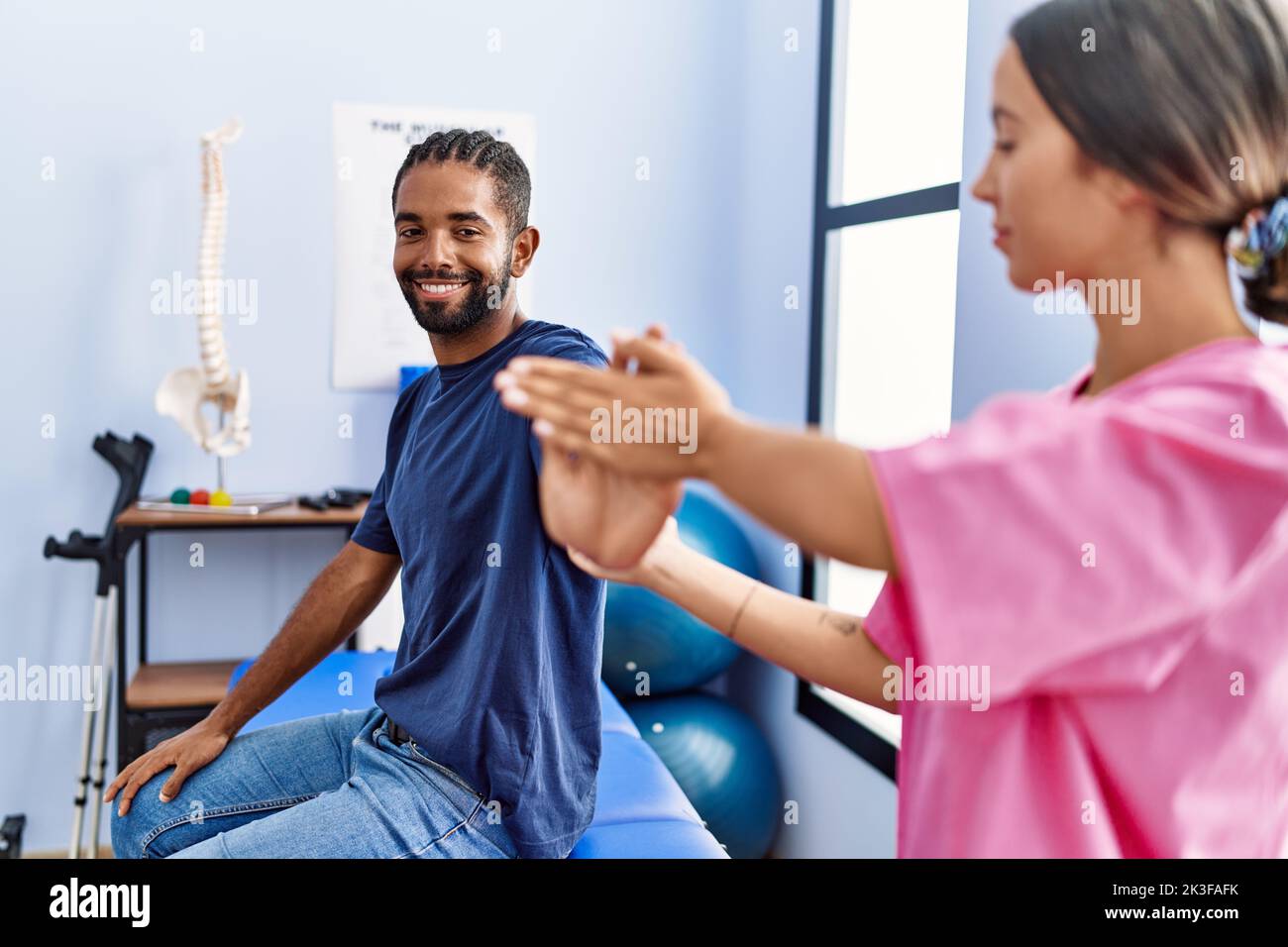 Man and woman wearing physiotherapist uniform having rehab session ...