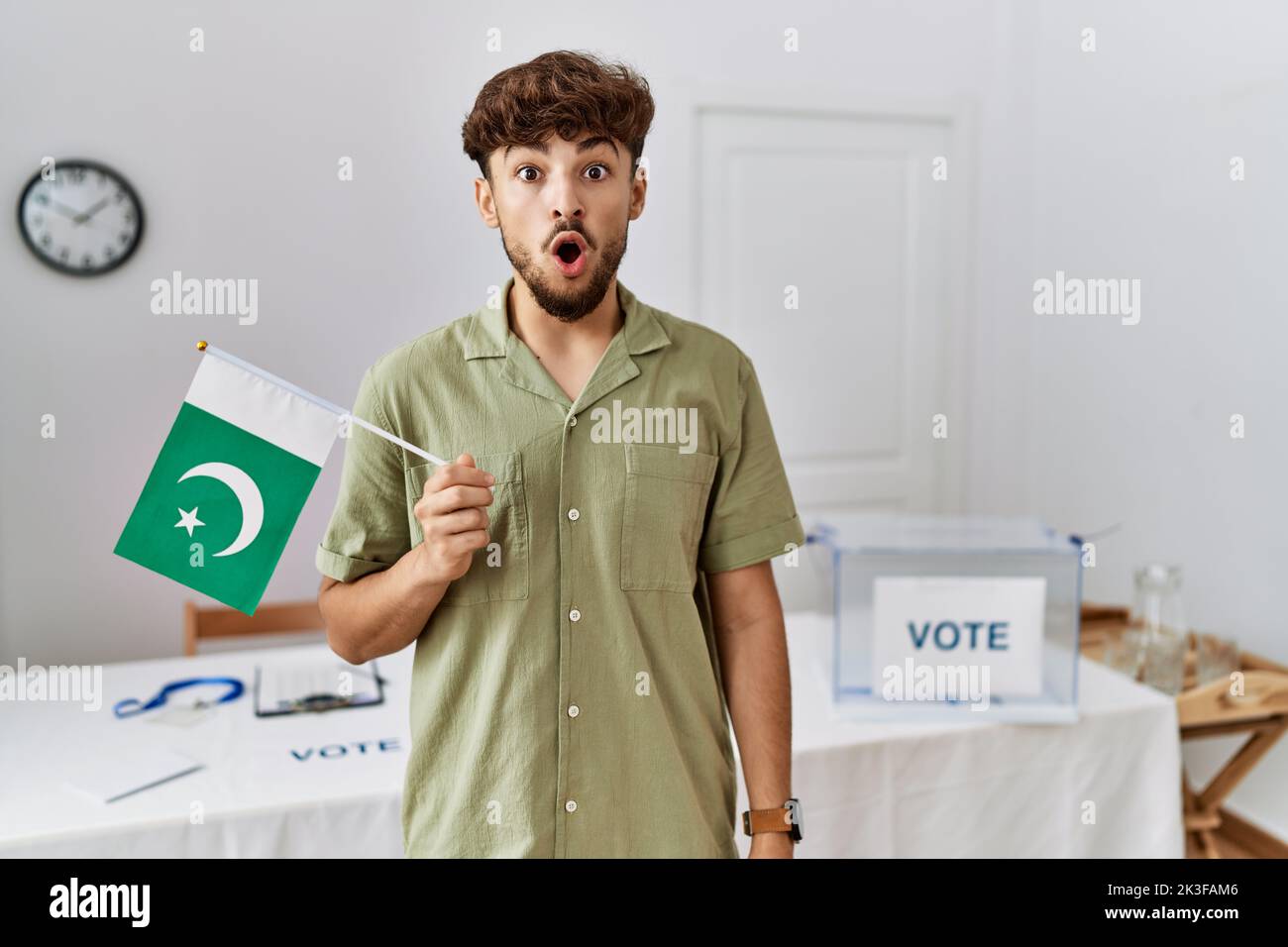 Young arab man at political campaign election holding pakistan flag ...