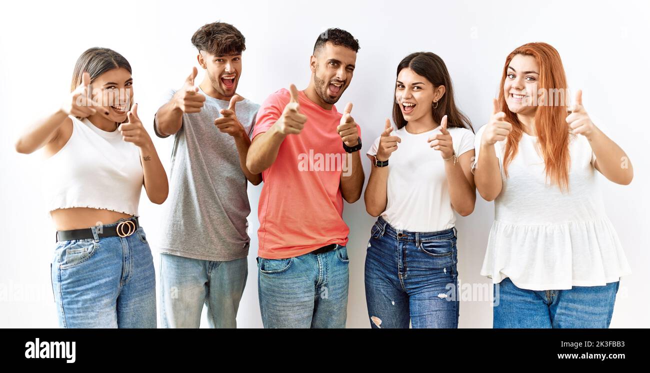 Group of young friends standing together over isolated background ...