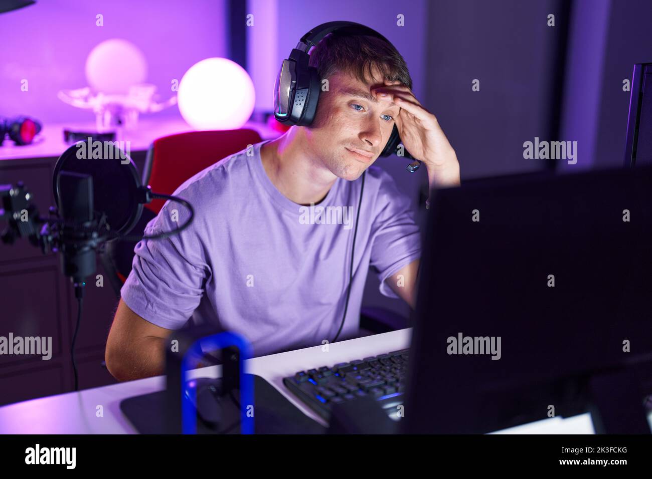 Young caucasian man streamer stressed using computer at gaming room ...