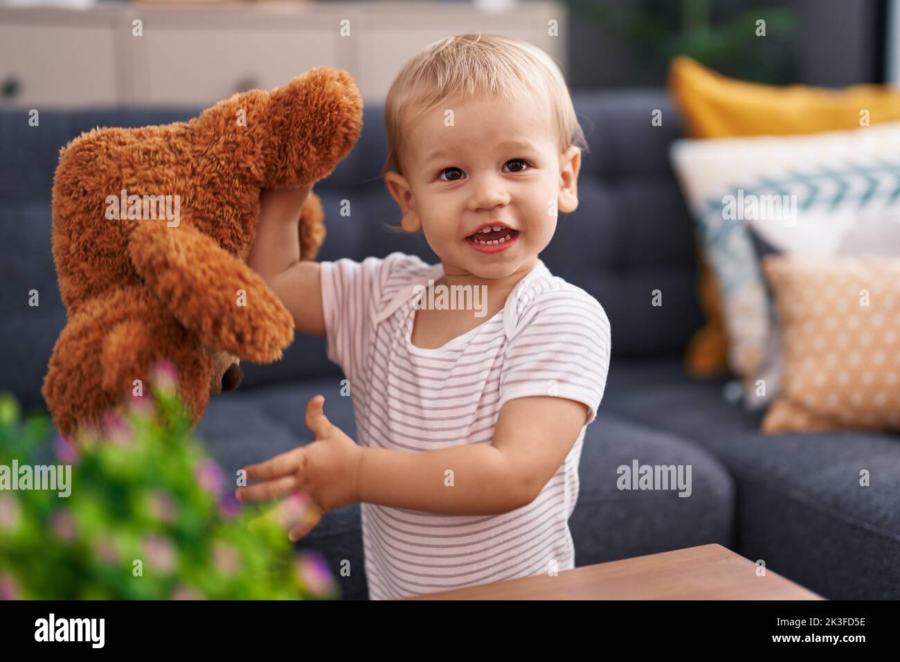 Adorable toddler smiling confident playing with teddy bear at home Stock Photo - Alamy