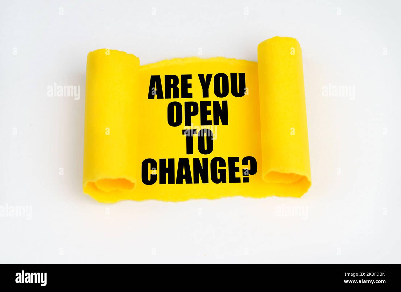 On a white surface, a yellow scroll of paper with the inscription - ARE ...