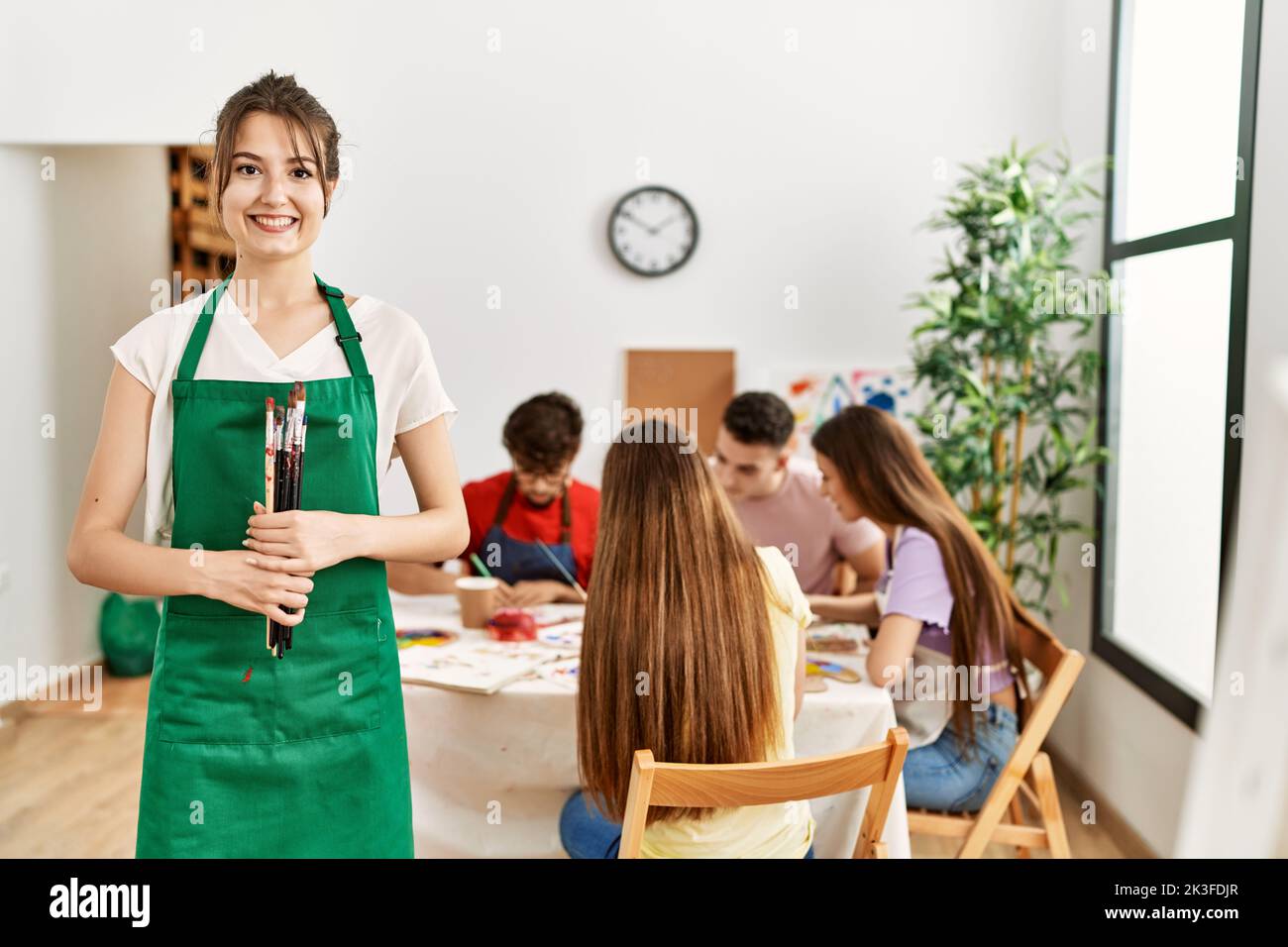 Group of people drawing sitting on the table. Woman smiling happy ...