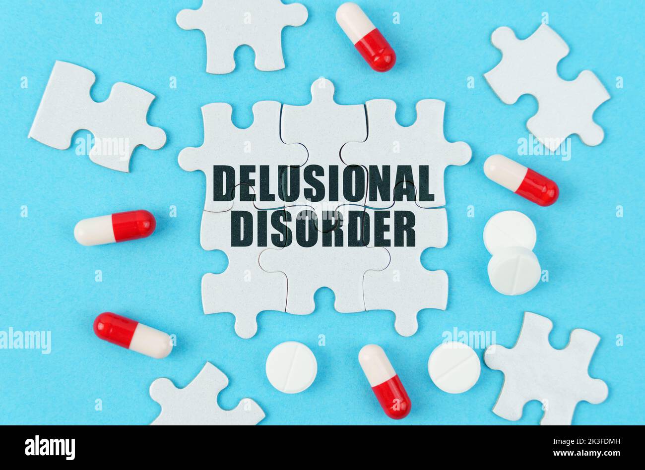 Medical concept. On a blue background, pills, capsules and puzzles with ...