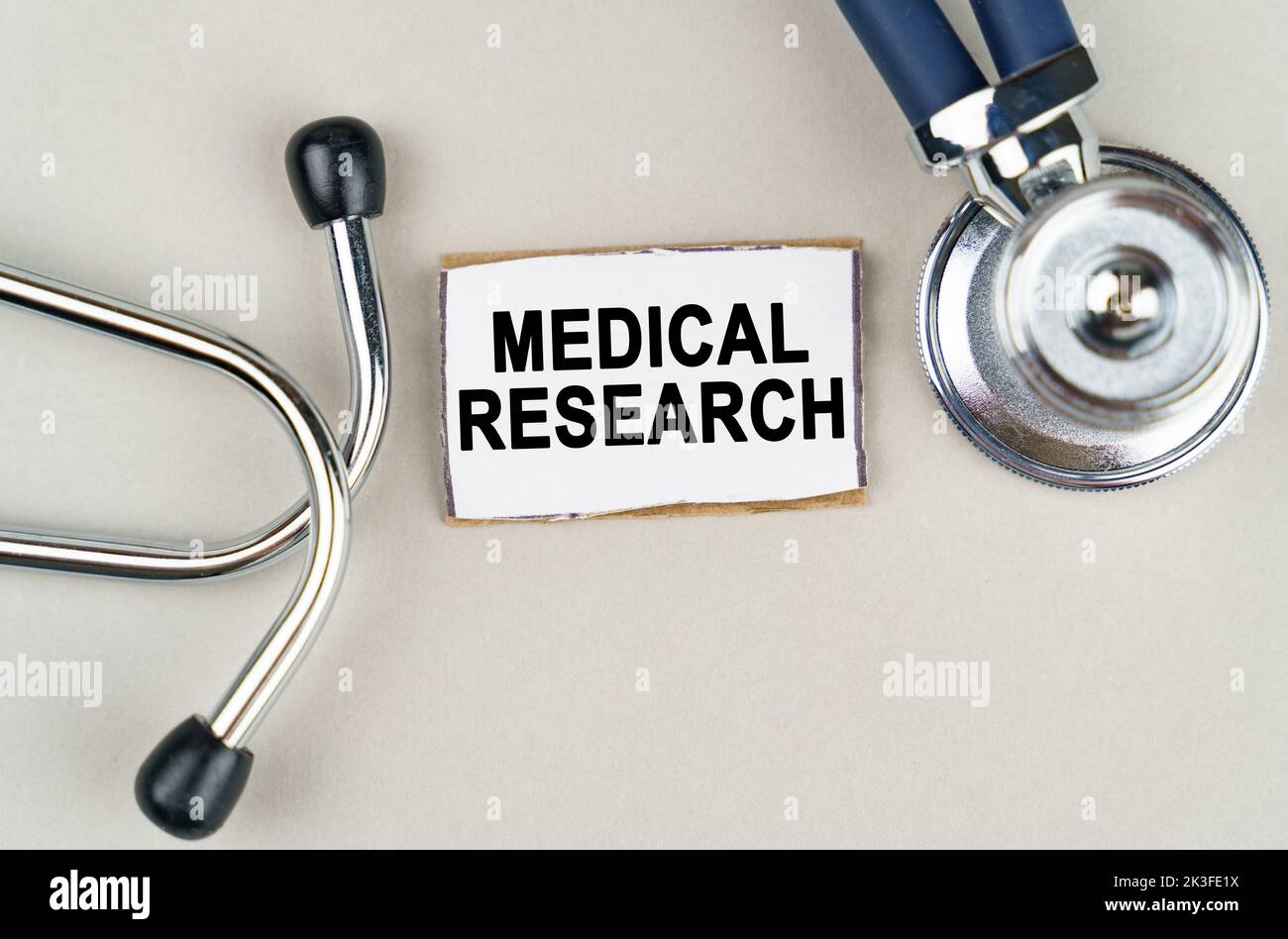 Medical concept. On a gray background, a stethoscope and a cardboard ...