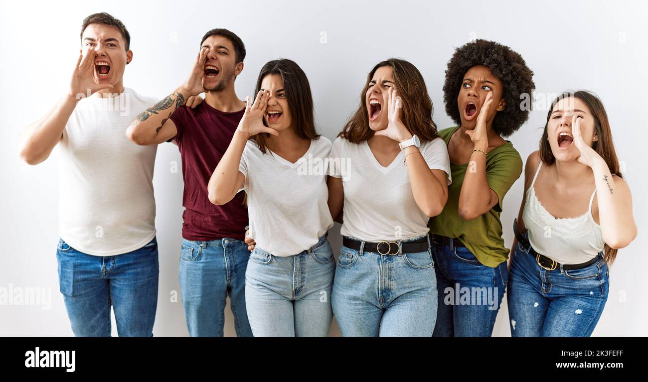 Group of young friends standing together over isolated background ...