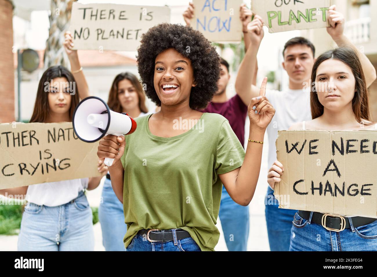 Group of young friends protesting and giving slogans at the street ...