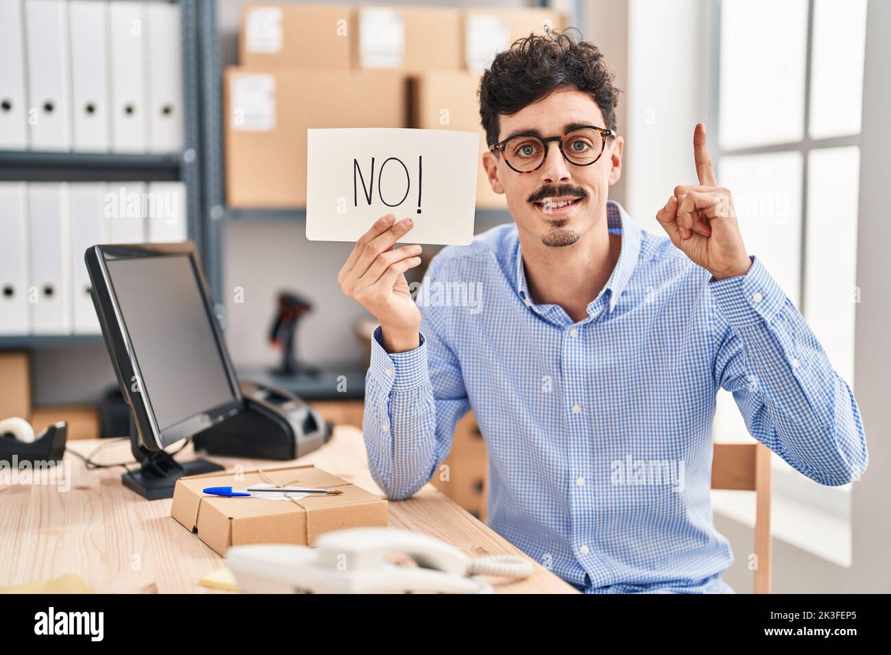 Hispanic man working at small business ecommerce holding no banner ...