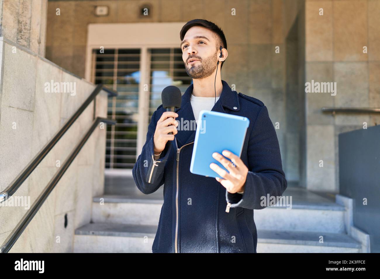 Young hispanic man reporter working using microphone and touchpad at street Stock Photo - Alamy