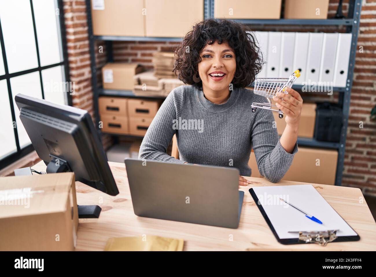 Hispanic doctor woman with curly hair standing by manikin at small ...