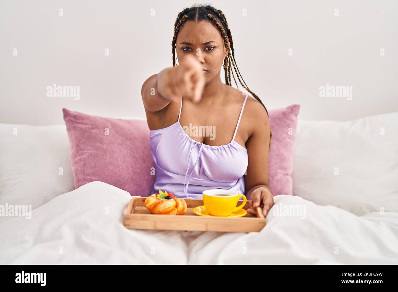 African american woman with braids holding tray with breakfast food in ...