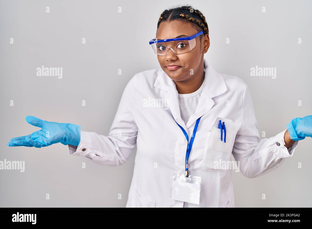 African american woman with braids wearing scientist robe clueless and ...