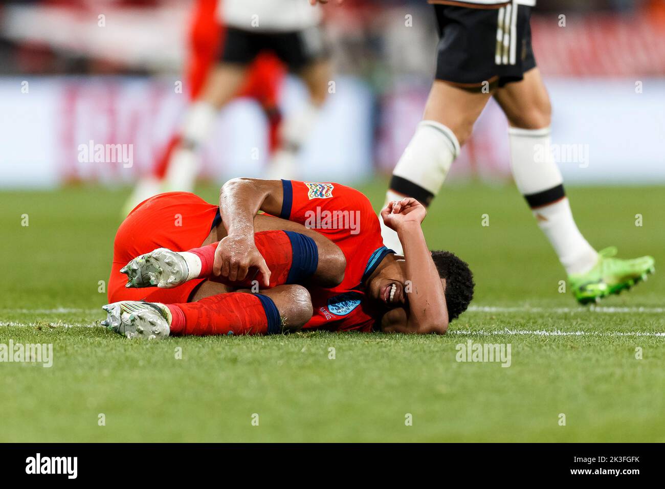 London, UK. 26th Sep, 2022. Jude Bellingham of England holds his leg ...