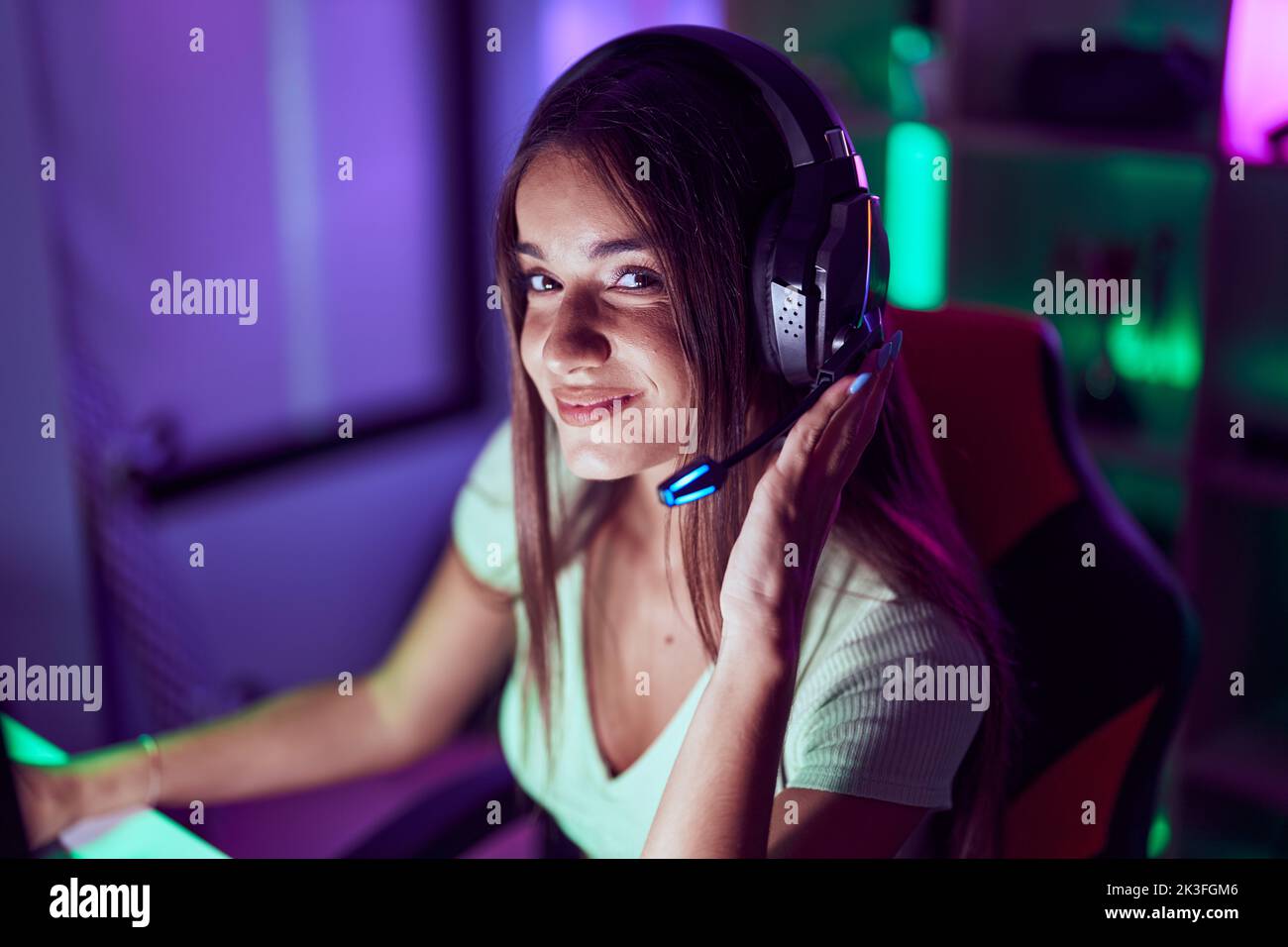 Young beautiful hispanic woman streamer playing video game using ...