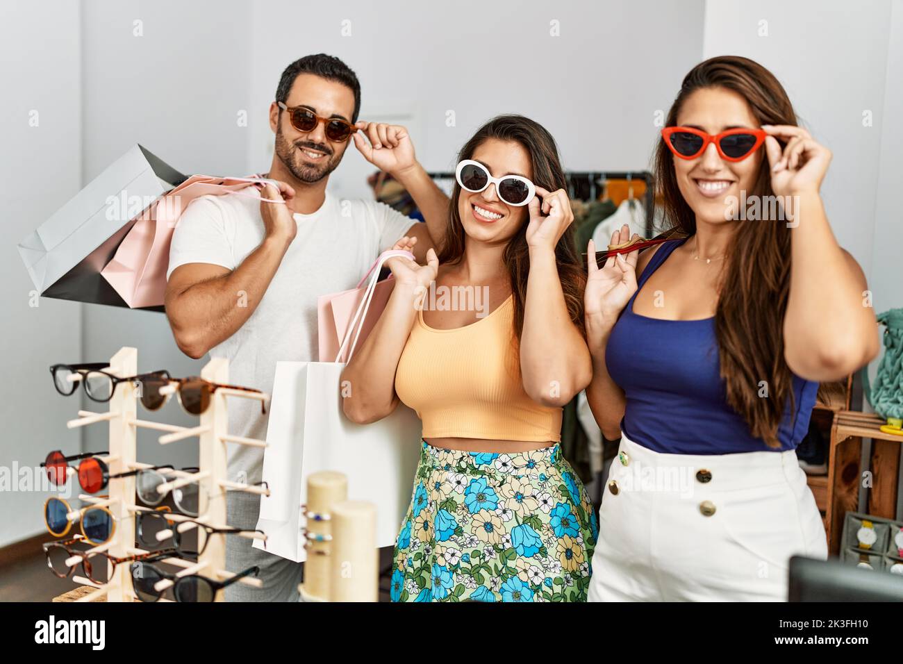 Group of young hispanic people smiling happy trying on sunglasses at ...