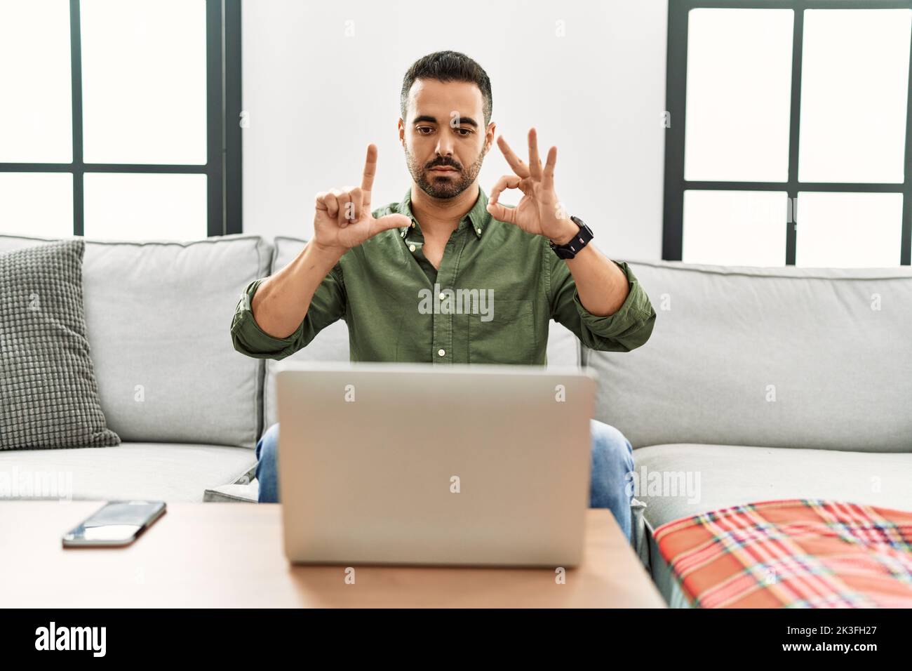 Young hispanic man having video call speaking with deaf language at ...