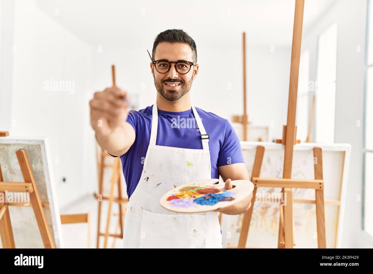 Young hispanic man smiling confident drawing at art studio Stock Photo ...