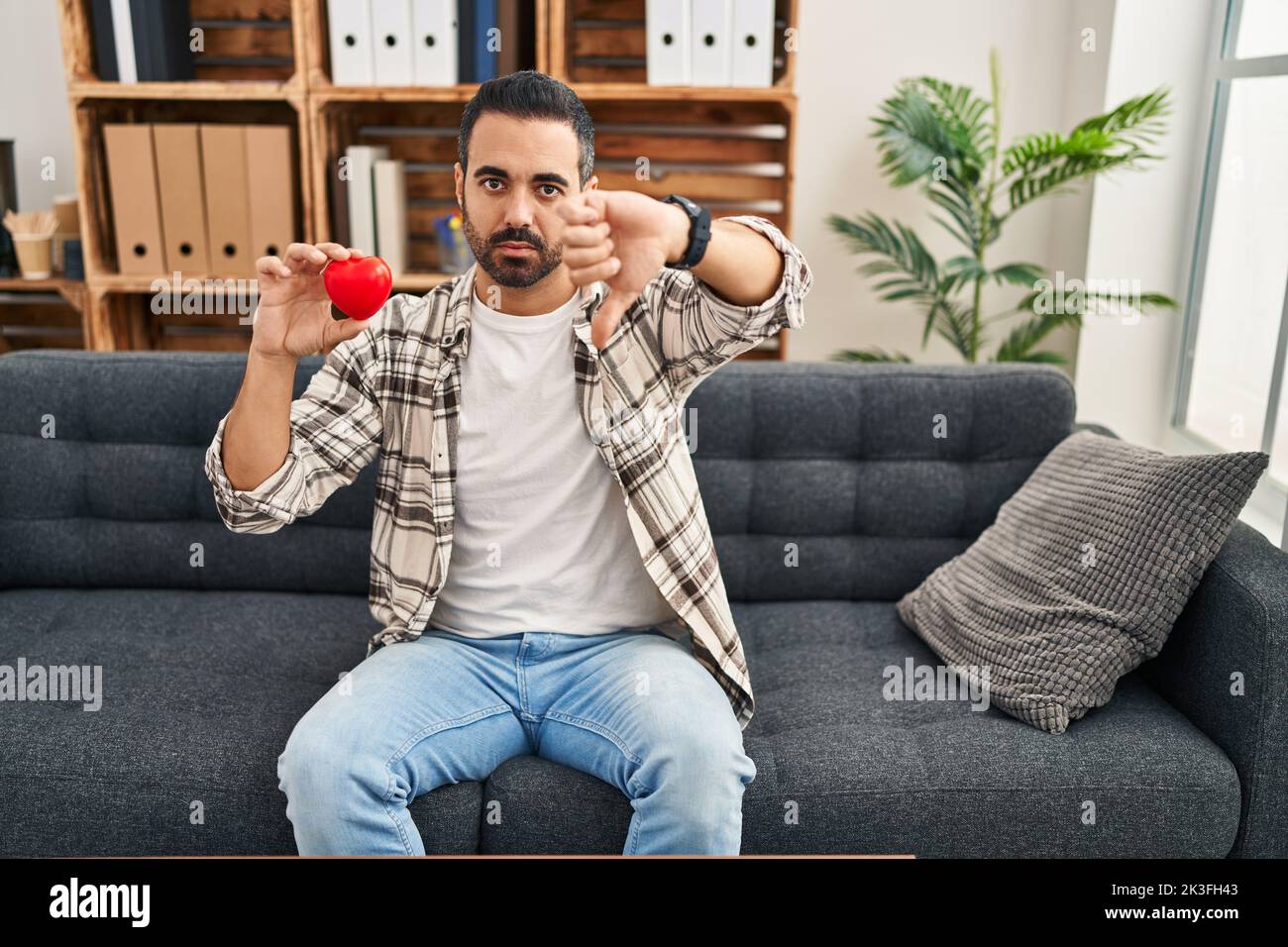 Young hispanic man with beard working on love therapy at consultation ...