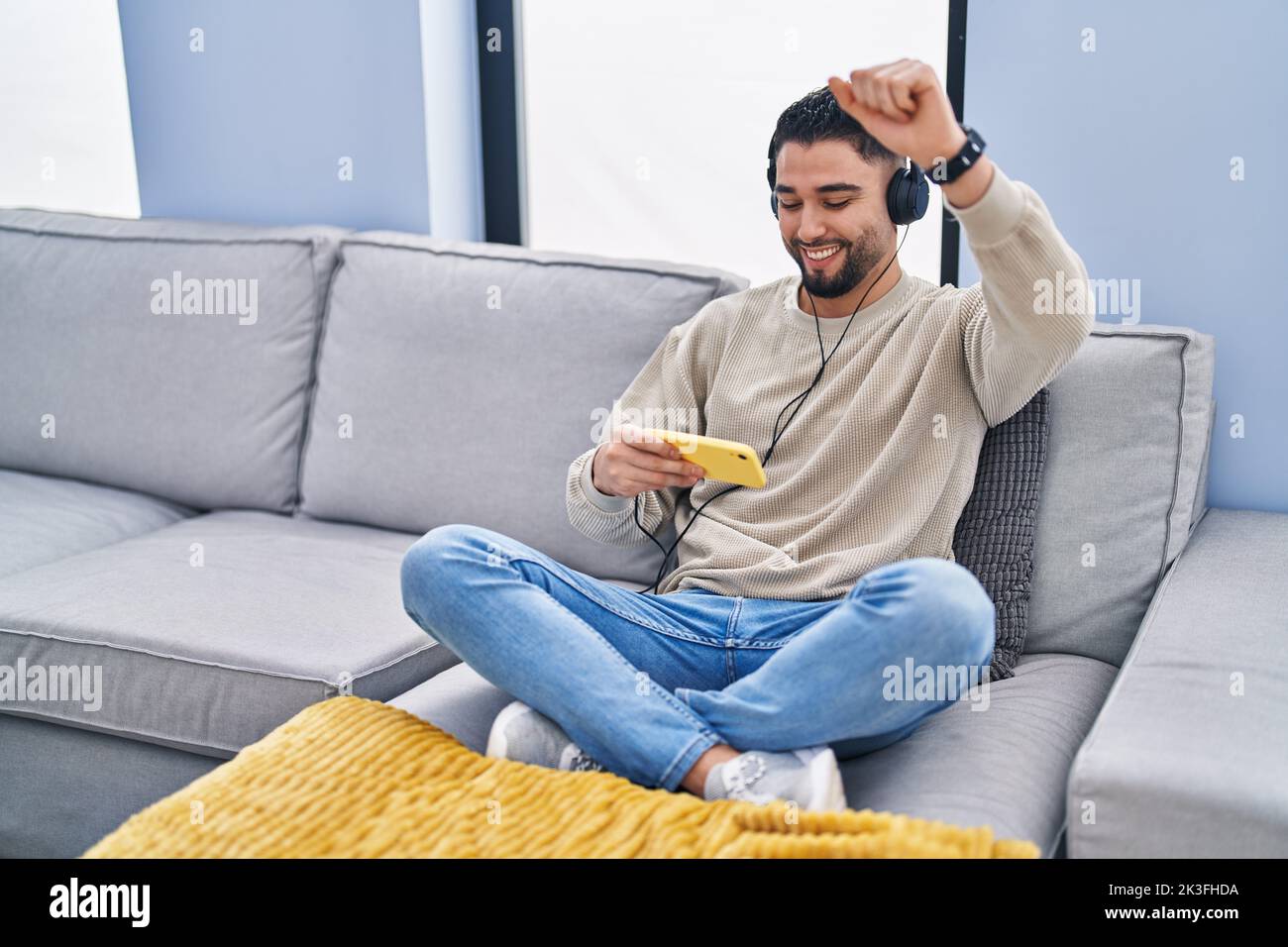 Young arab man smiling confident playing video game at home Stock Photo ...