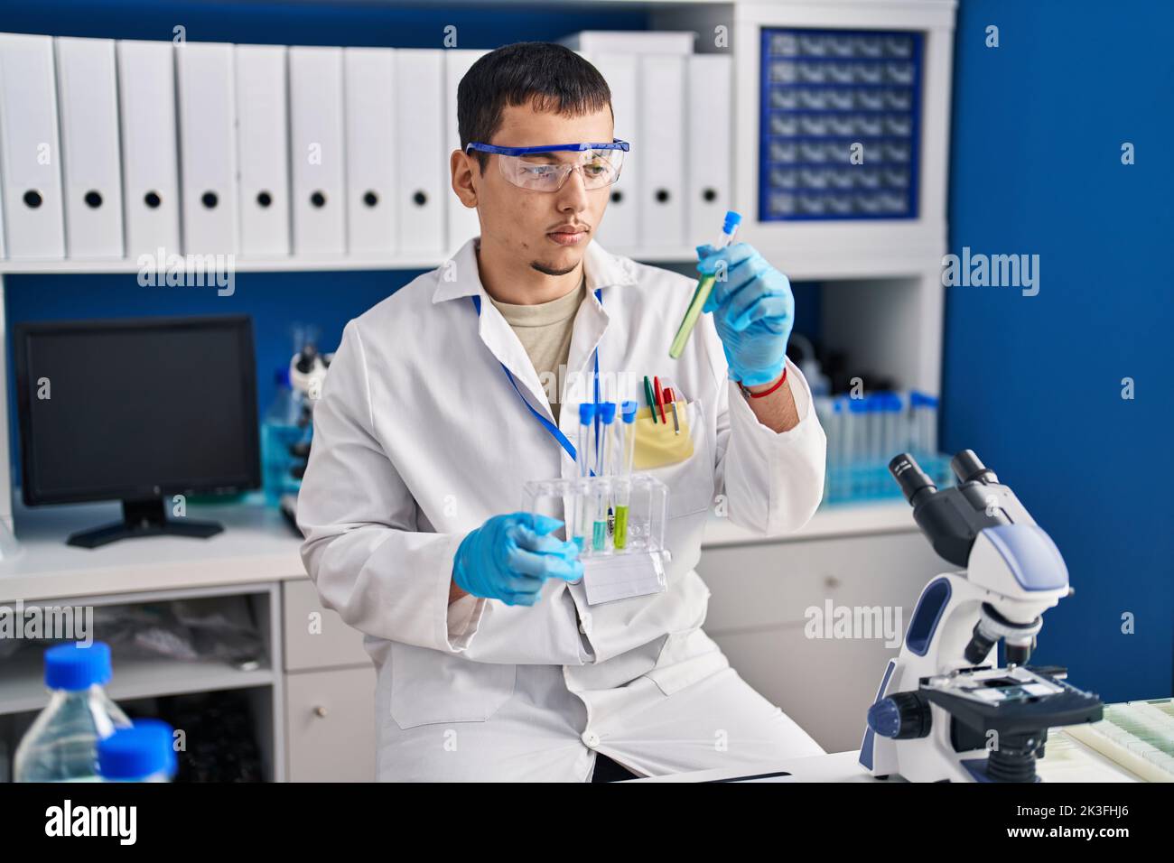 Young man scientist holding test tubes at laboratory Stock Photo - Alamy