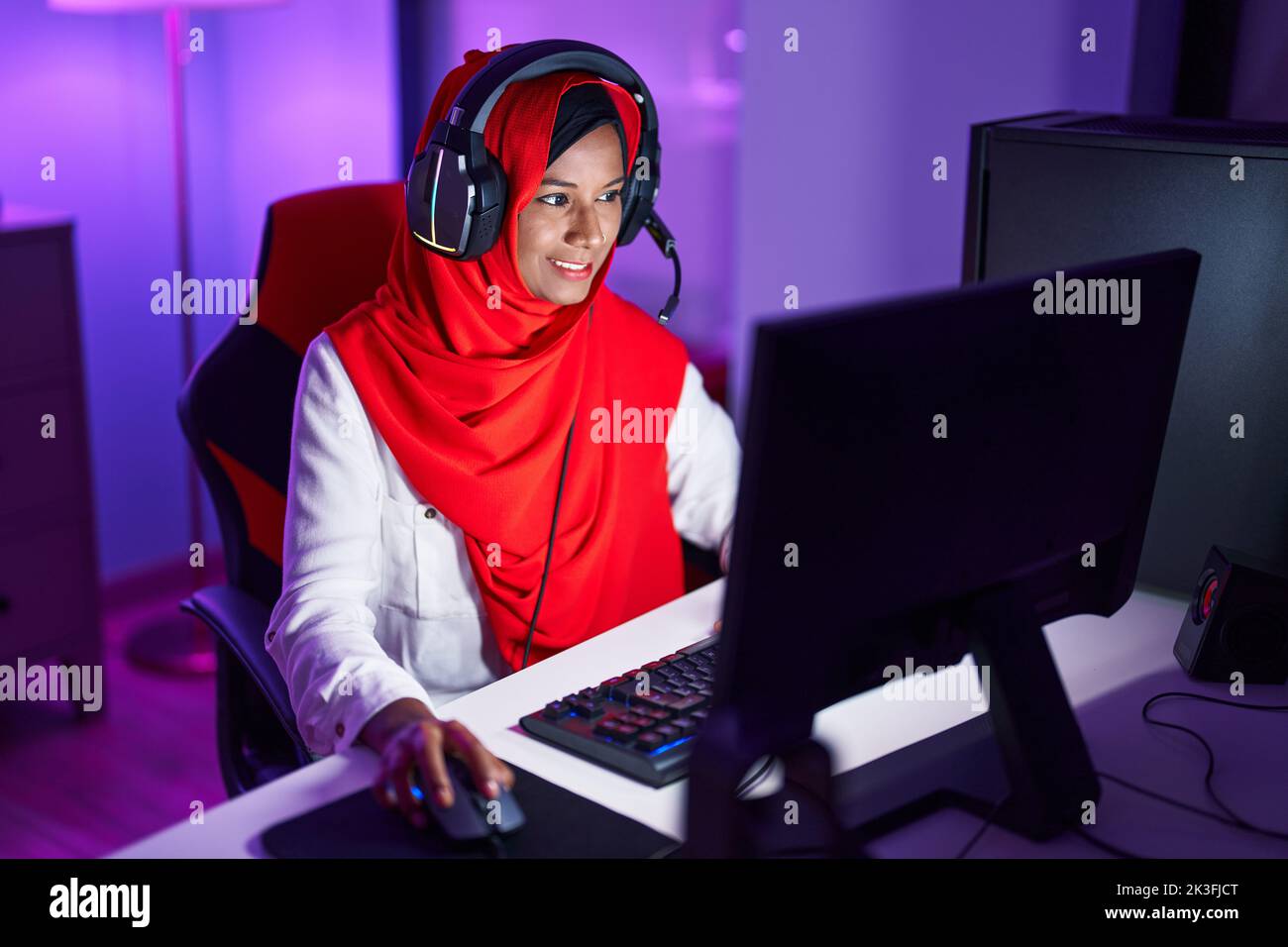 Young beautiful woman streamer playing video game using computer at ...