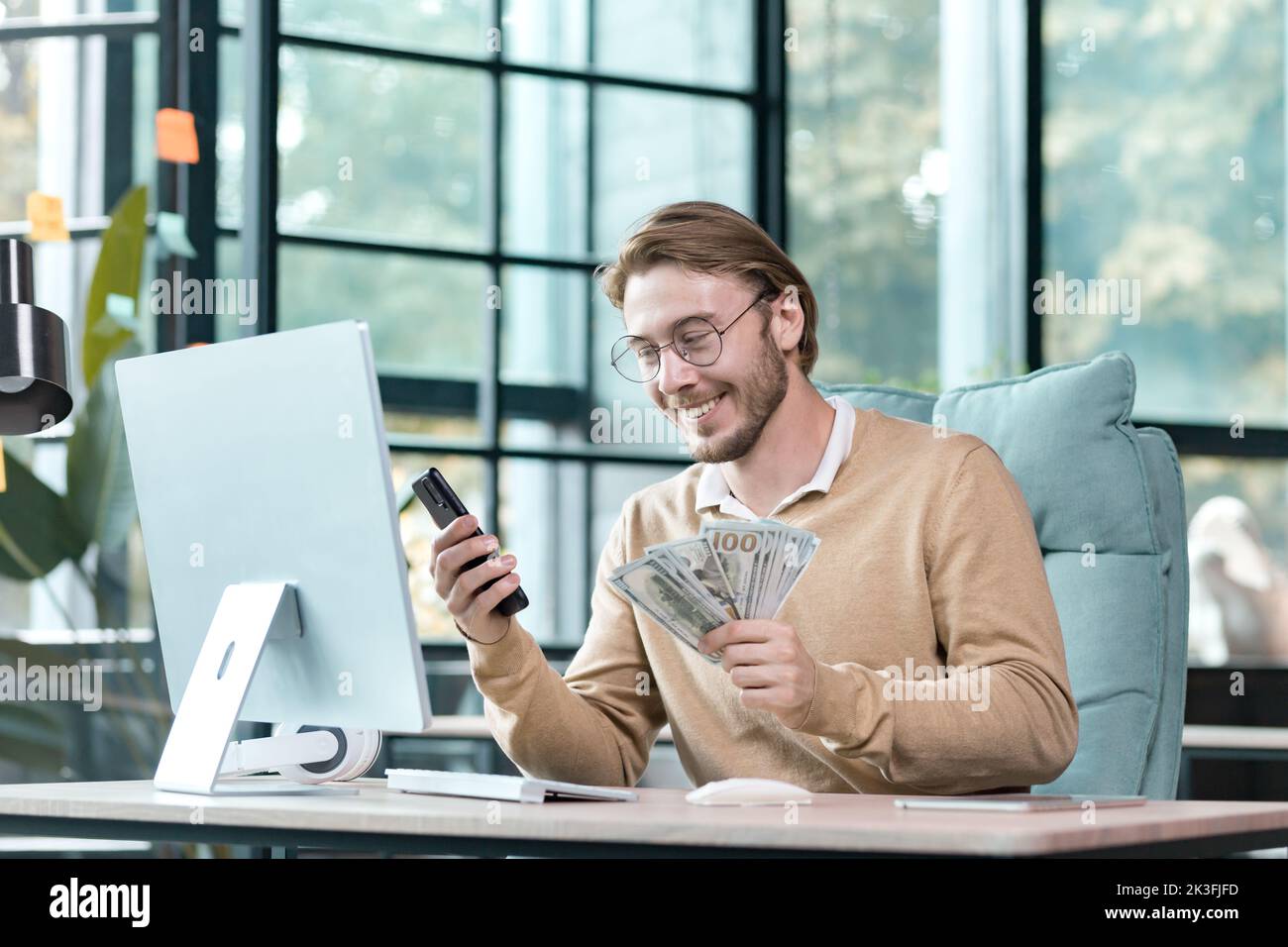 Young successful businessman working inside modern loft office, happy ...