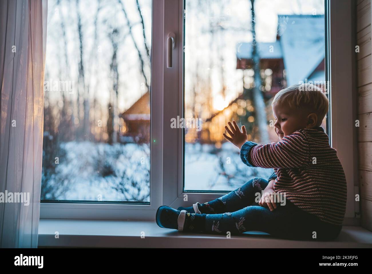 Child Looking Out A Window