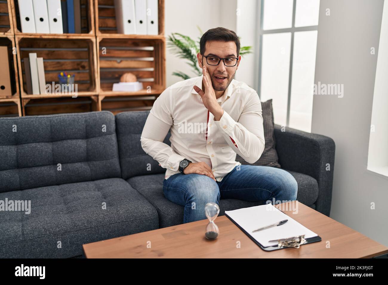 Young hispanic man with beard working at consultation office hand on ...