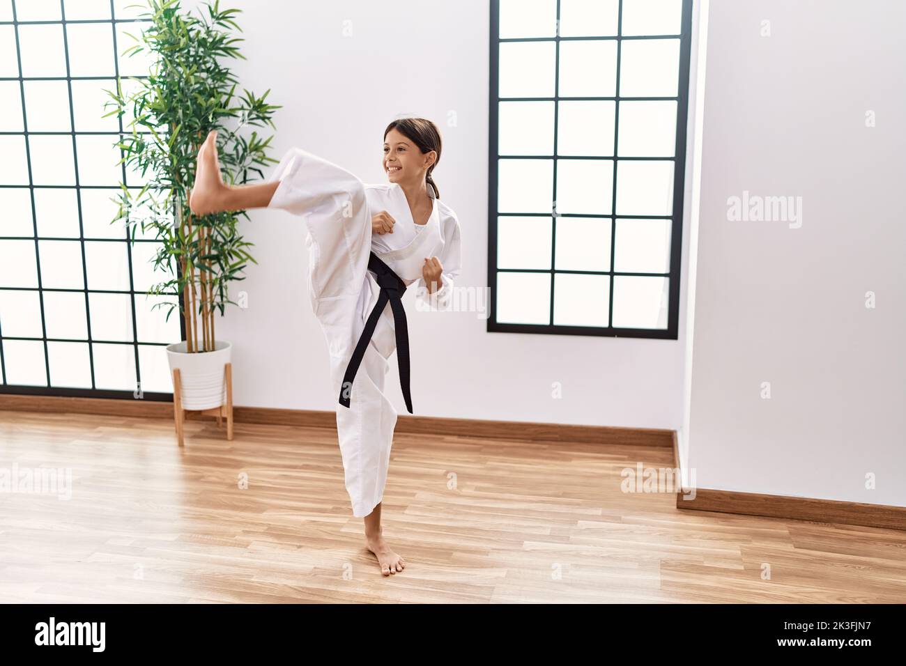 Young hispanic girl doing martial arts at training studio Stock Photo - Alamy