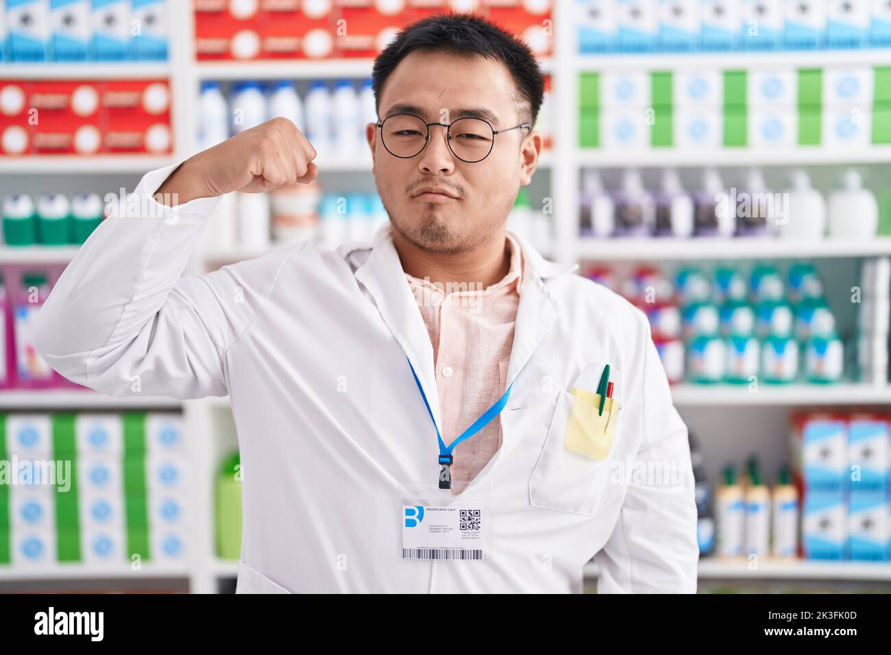 Chinese young man working at pharmacy drugstore strong person showing ...