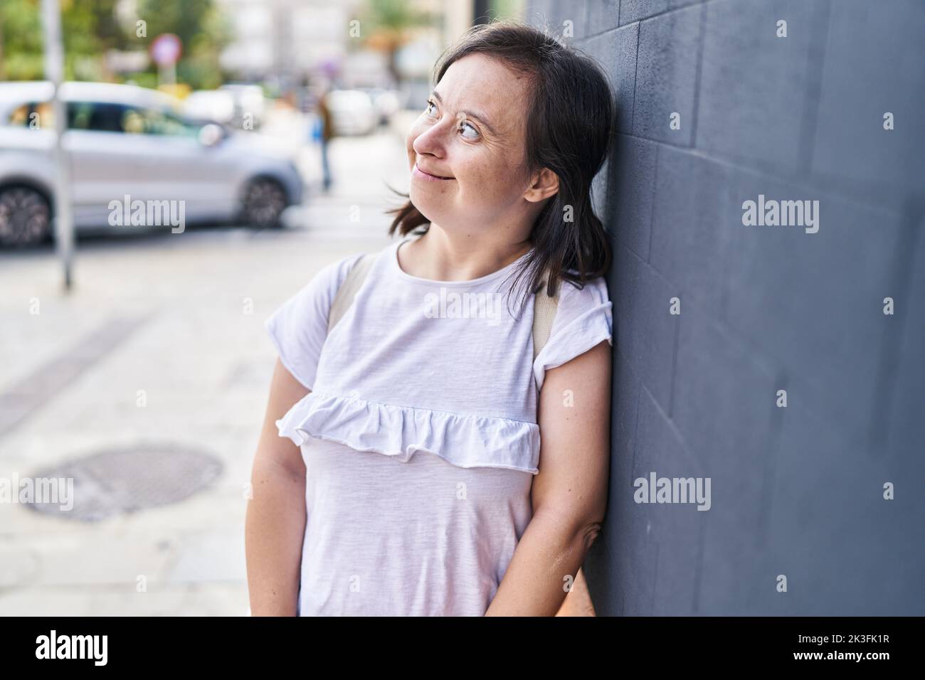 Down syndrome woman smiling confident standing at street Stock Photo ...