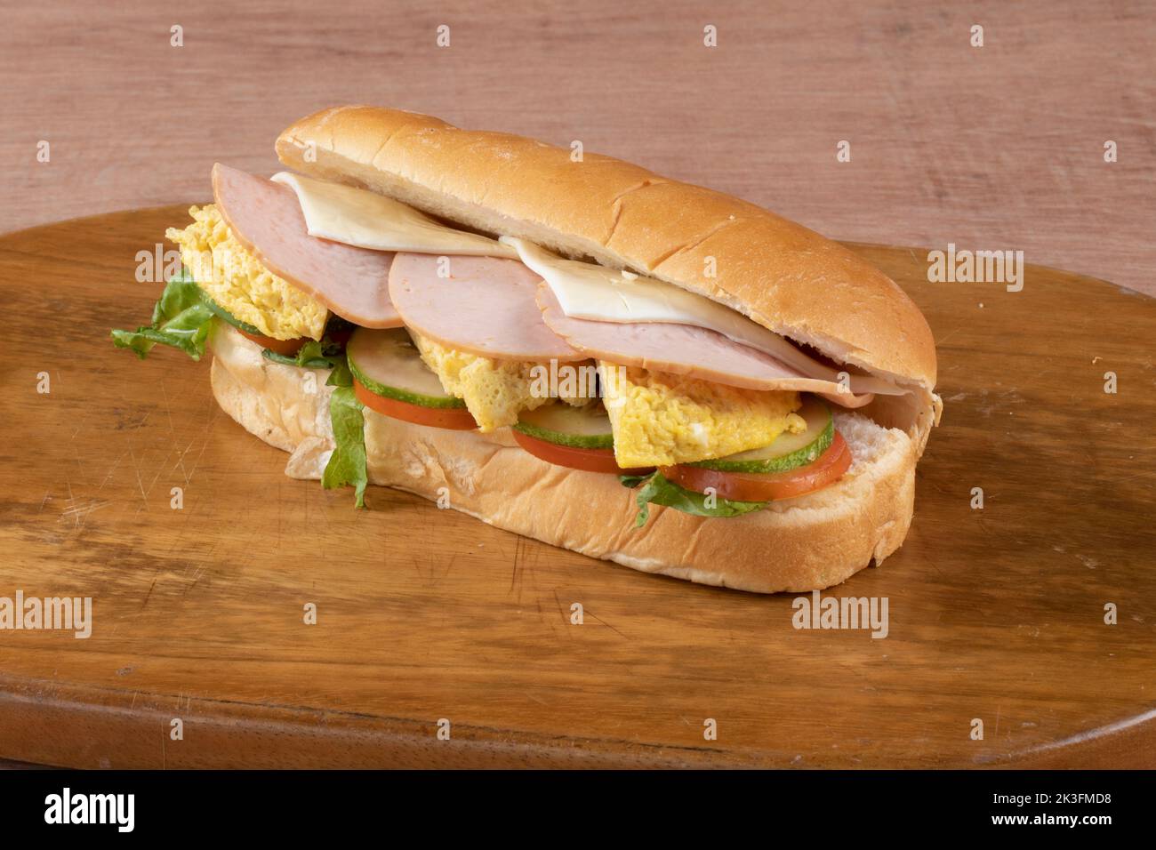 fresh submarine sandwiches with ham, cheese, bacon, tomatoes, lettuce ...