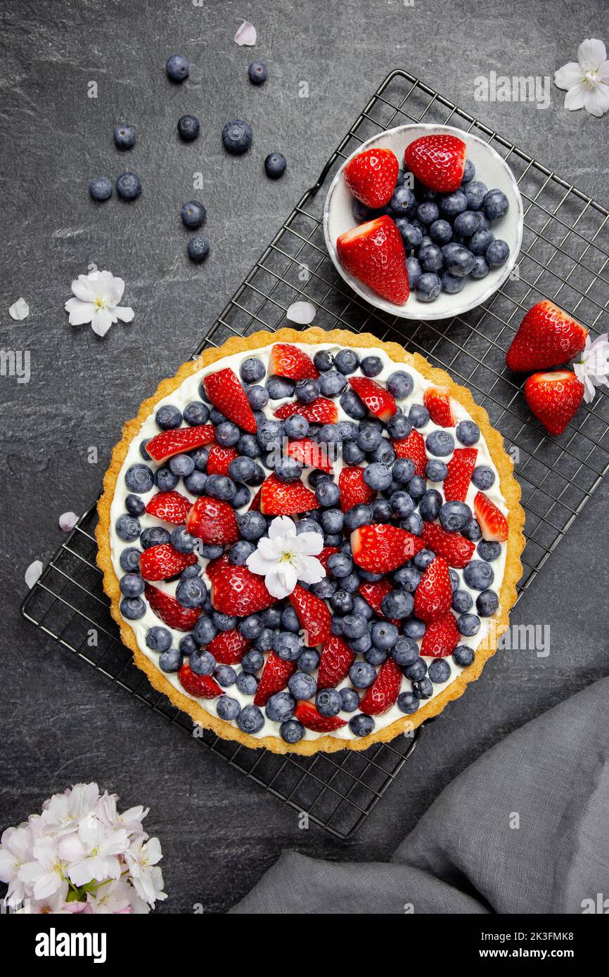 Delicious blueberry and strawberry tart with whipped cream and ...
