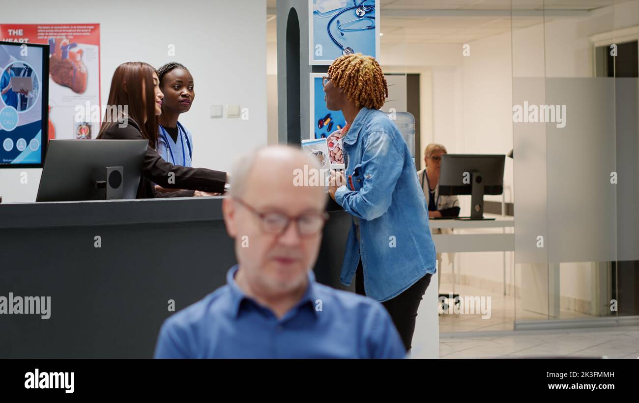 African american patient filling in medical report before examination ...