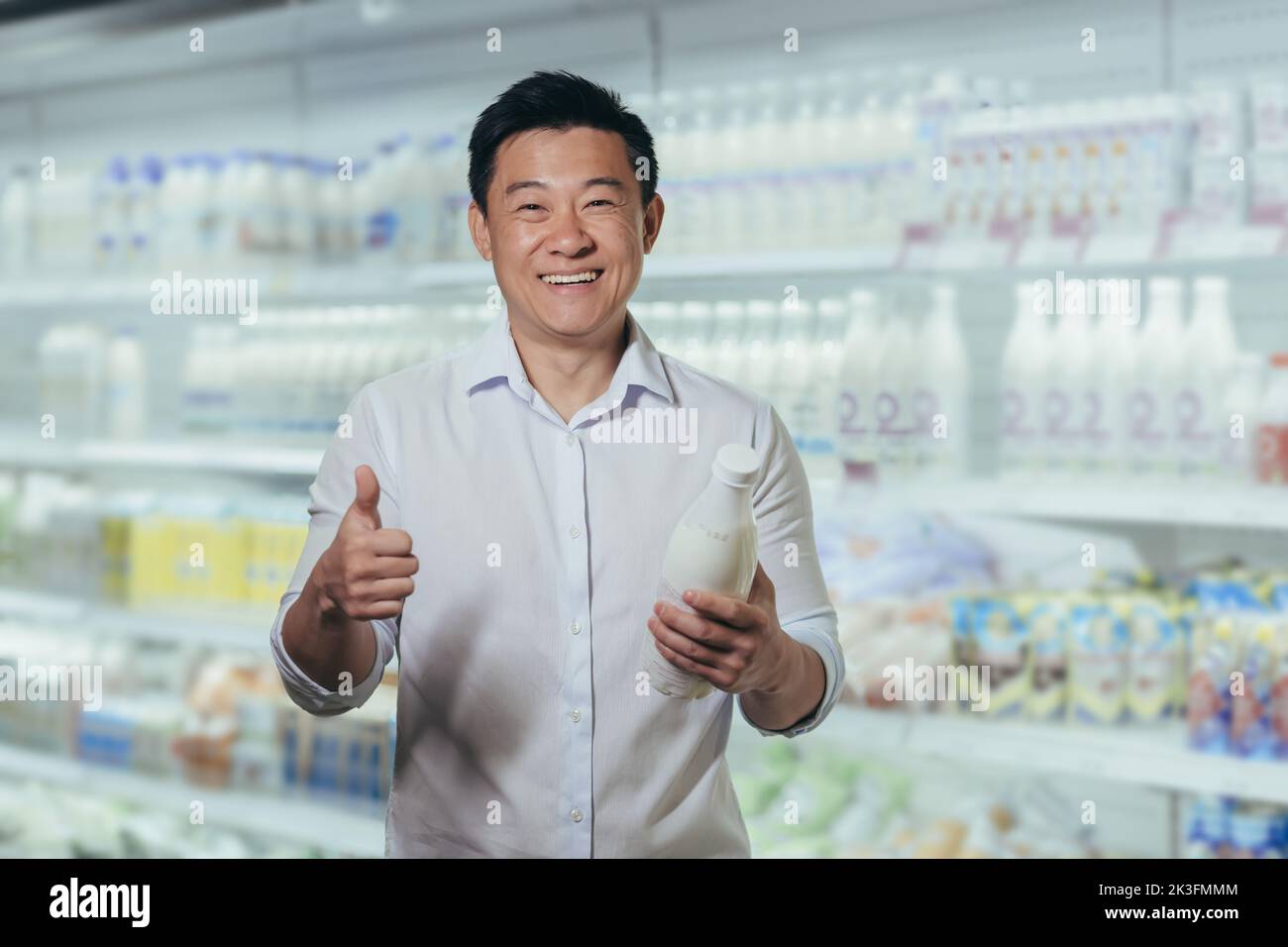 Advertising. Portrait of a young handsome Asian man standing in a ...