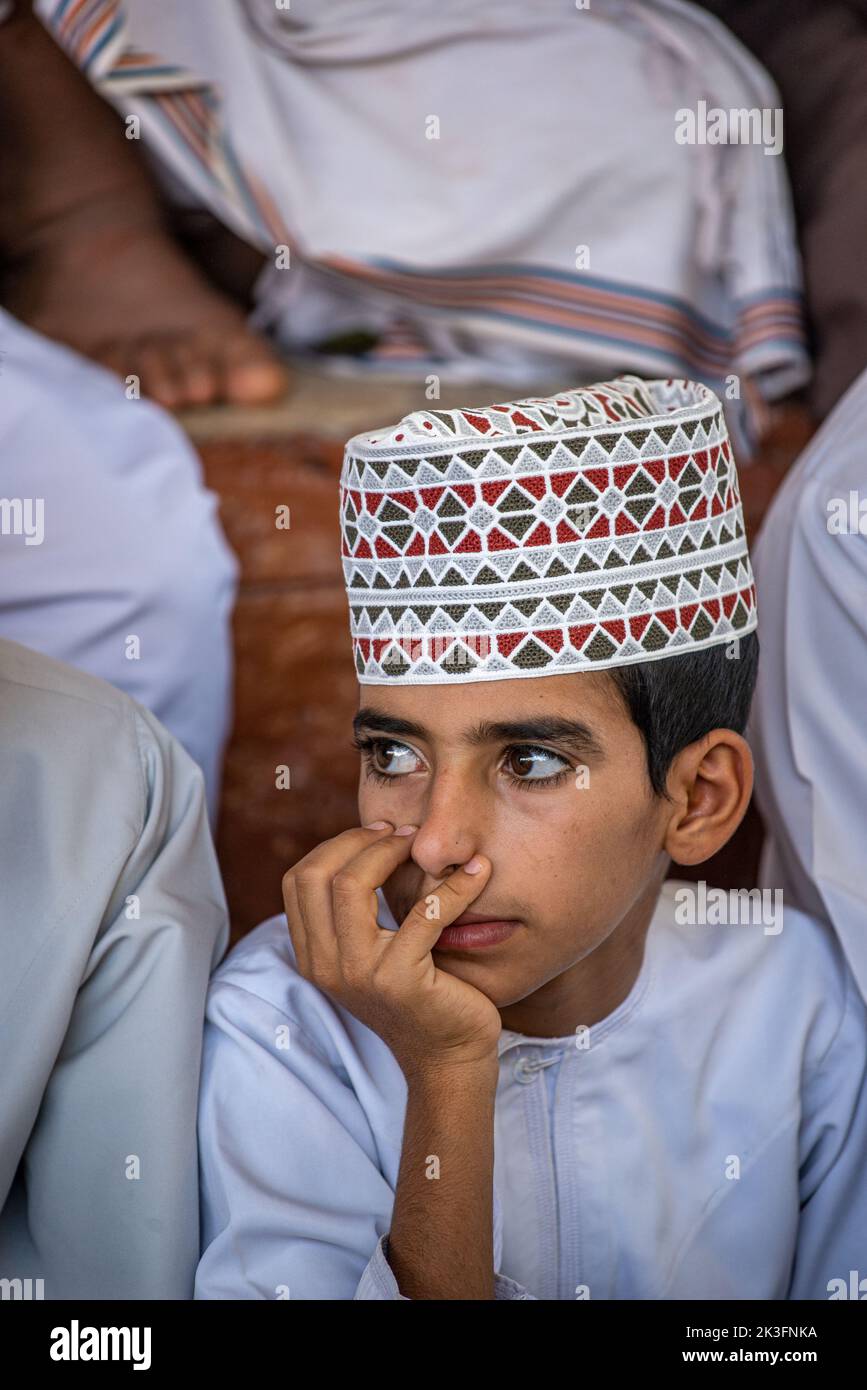 Portrait of a young boy with kuma (omani traditional round hat) at ...