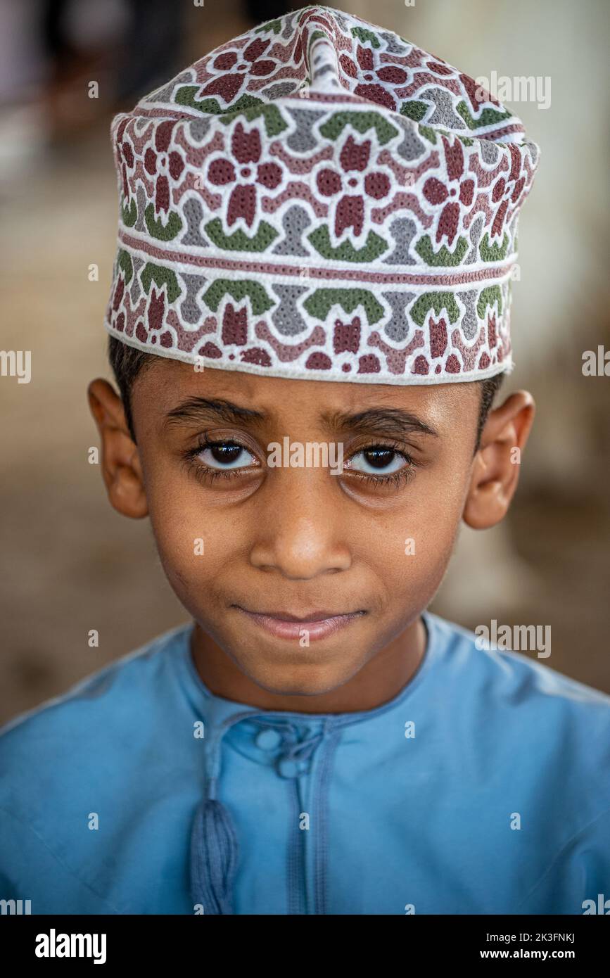 Portrait of a young boy with kuma (omani traditional round hat) at ...
