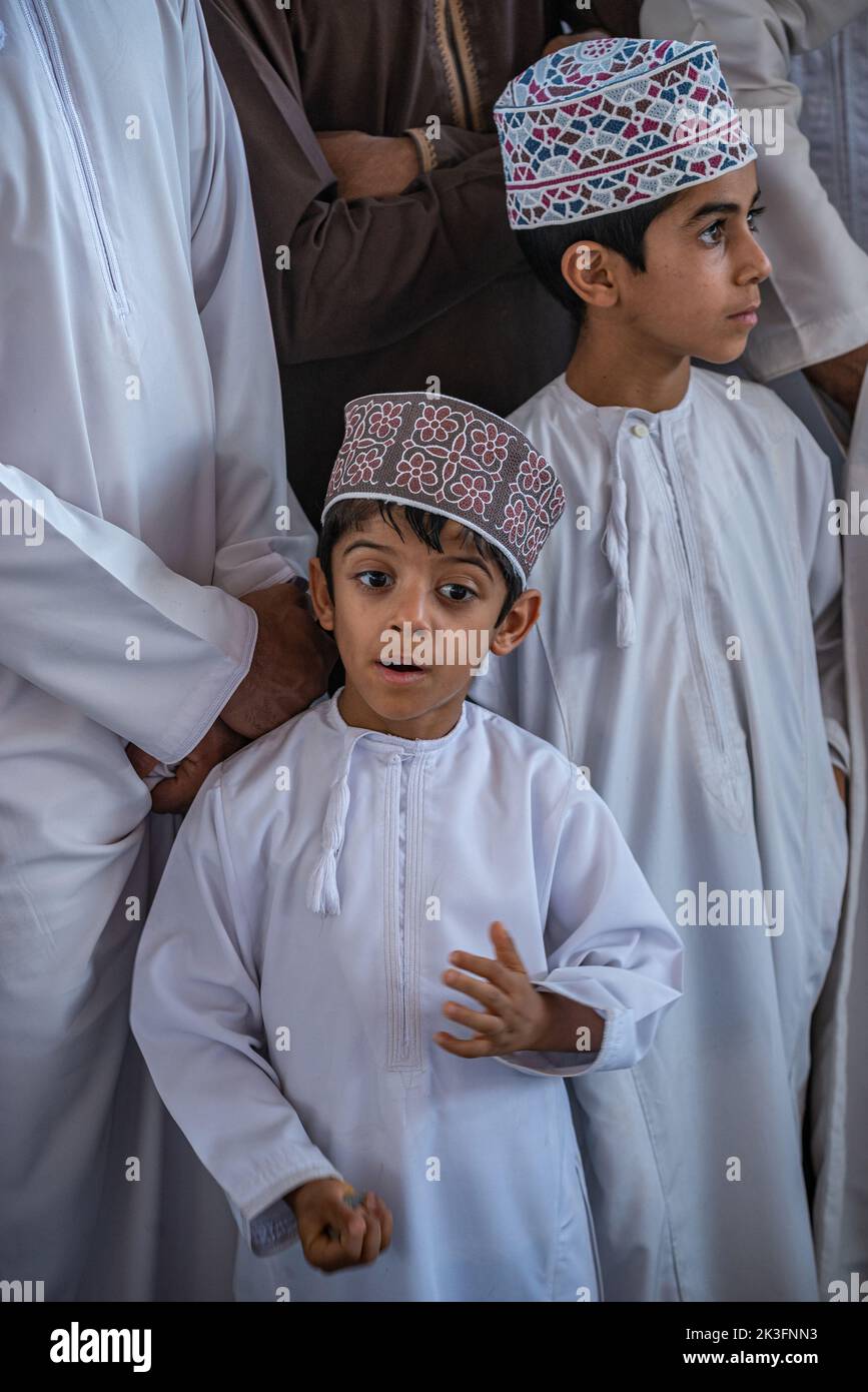 Two young boys with kuma (omani traditional round hat) at friday ...