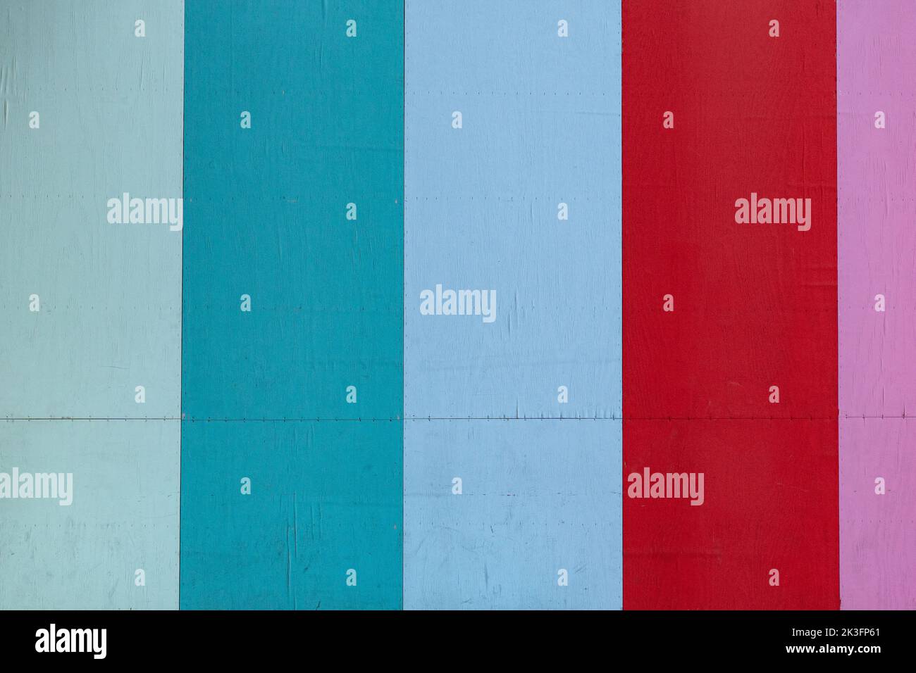 Vertical painted stripes of blue shades and red color. wooden colorful ...