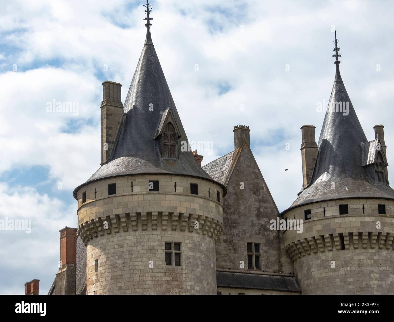 Castle roof the grey slate tiled rooves , two turrets and blue sky ...