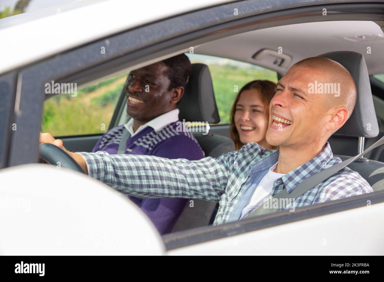 Happy friends driving in the car with open windows Stock Photo - Alamy