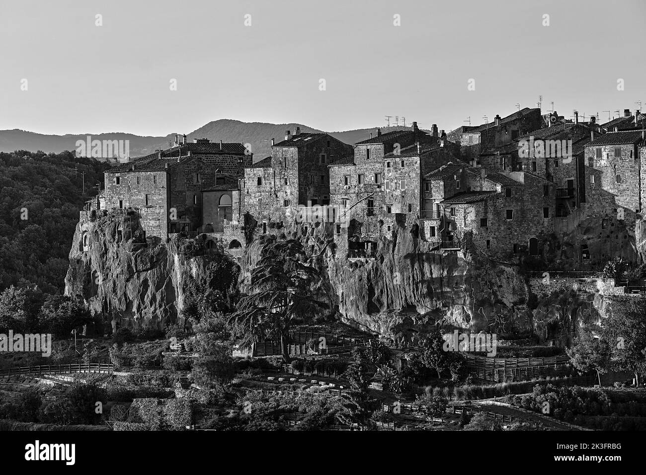 Medieval stone buildings on a rocky cliff in the town of Pitigliano in ...