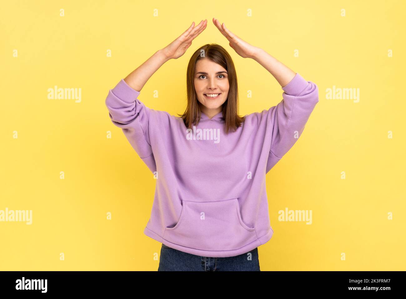 I'm in safety. Portrait of happy protected woman raising hands above ...