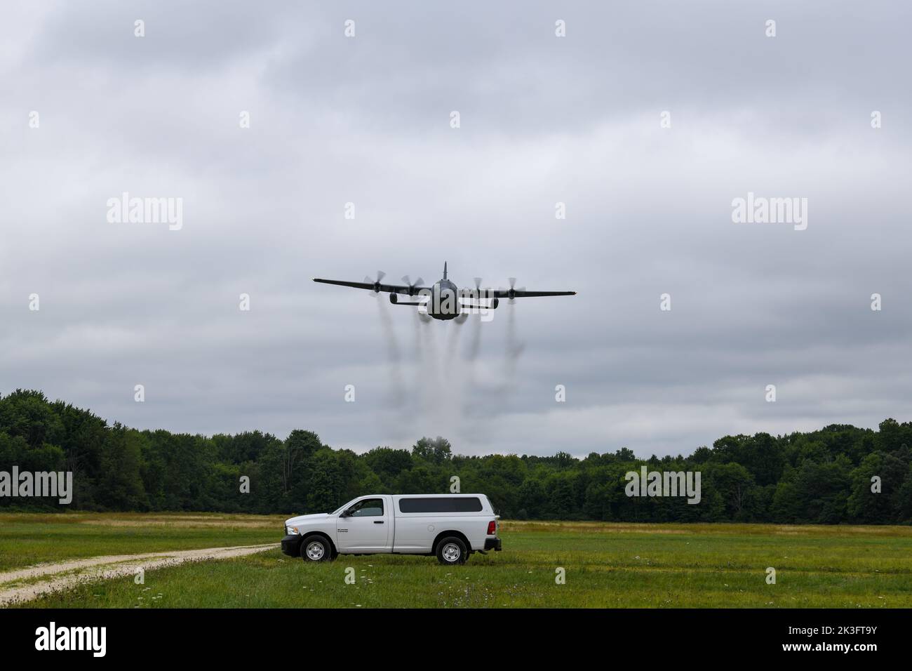 A C-130H Hercules performs an aerial pesticide application pass using a ...