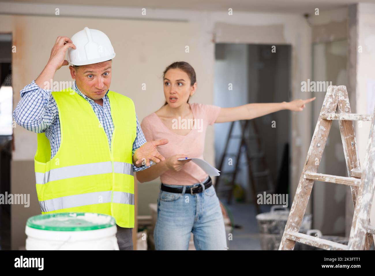 Woman construction manager firing man builder Stock Photo - Alamy