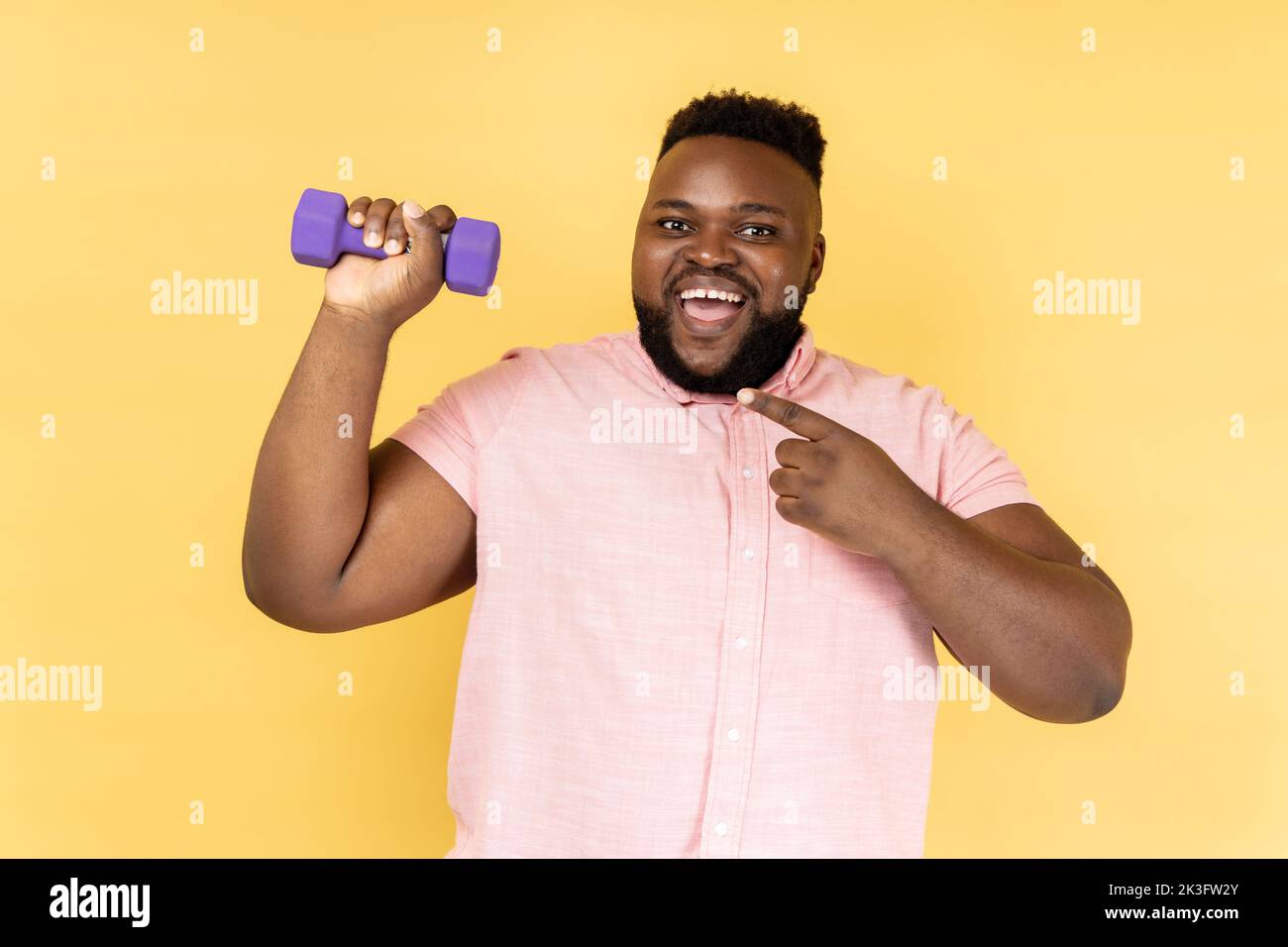 Portrait of excited positive bearded man wearing pink shirt standing ...