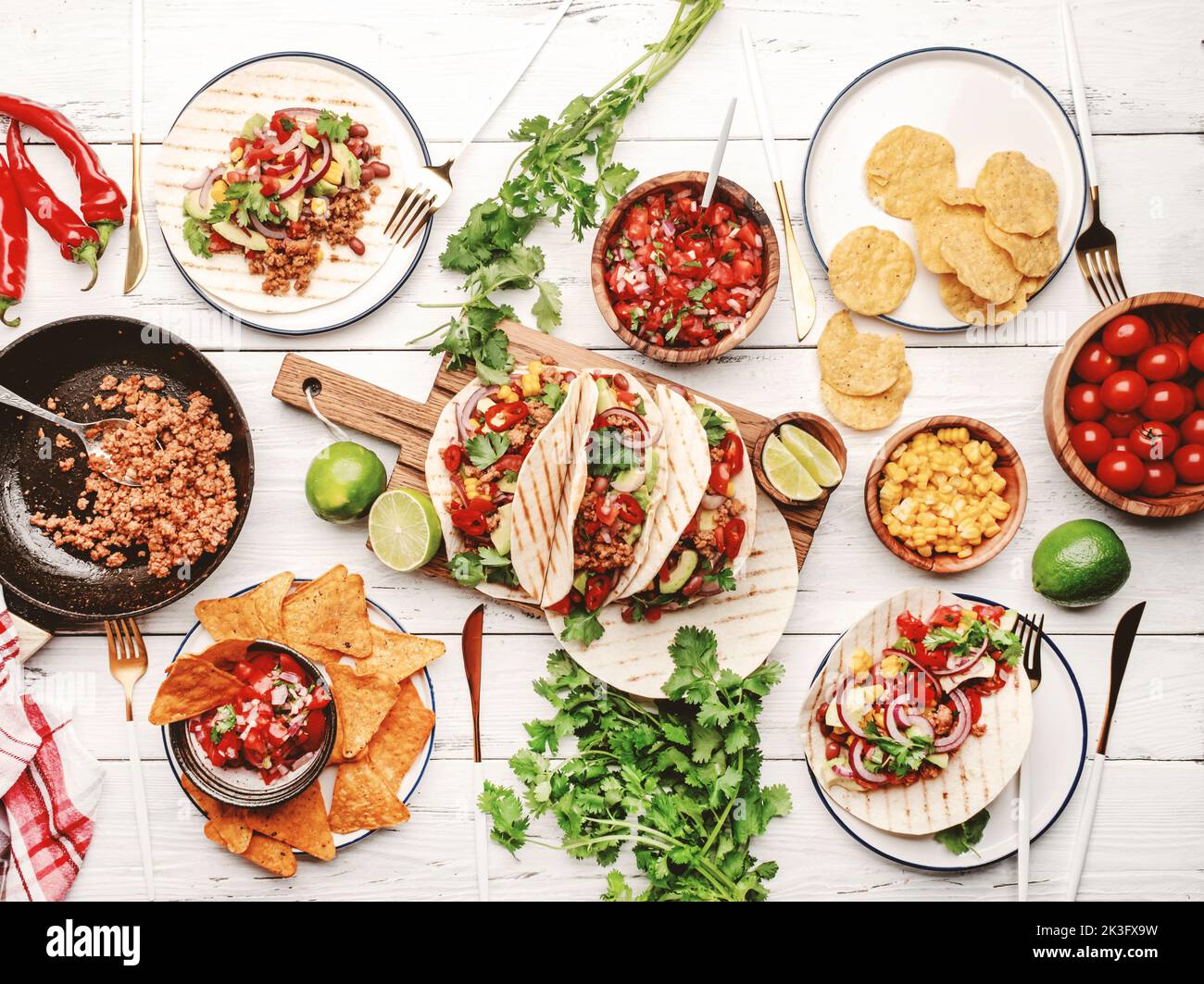 Taco party. Served table with tortillas, nachos, sauces, appetizers and ...
